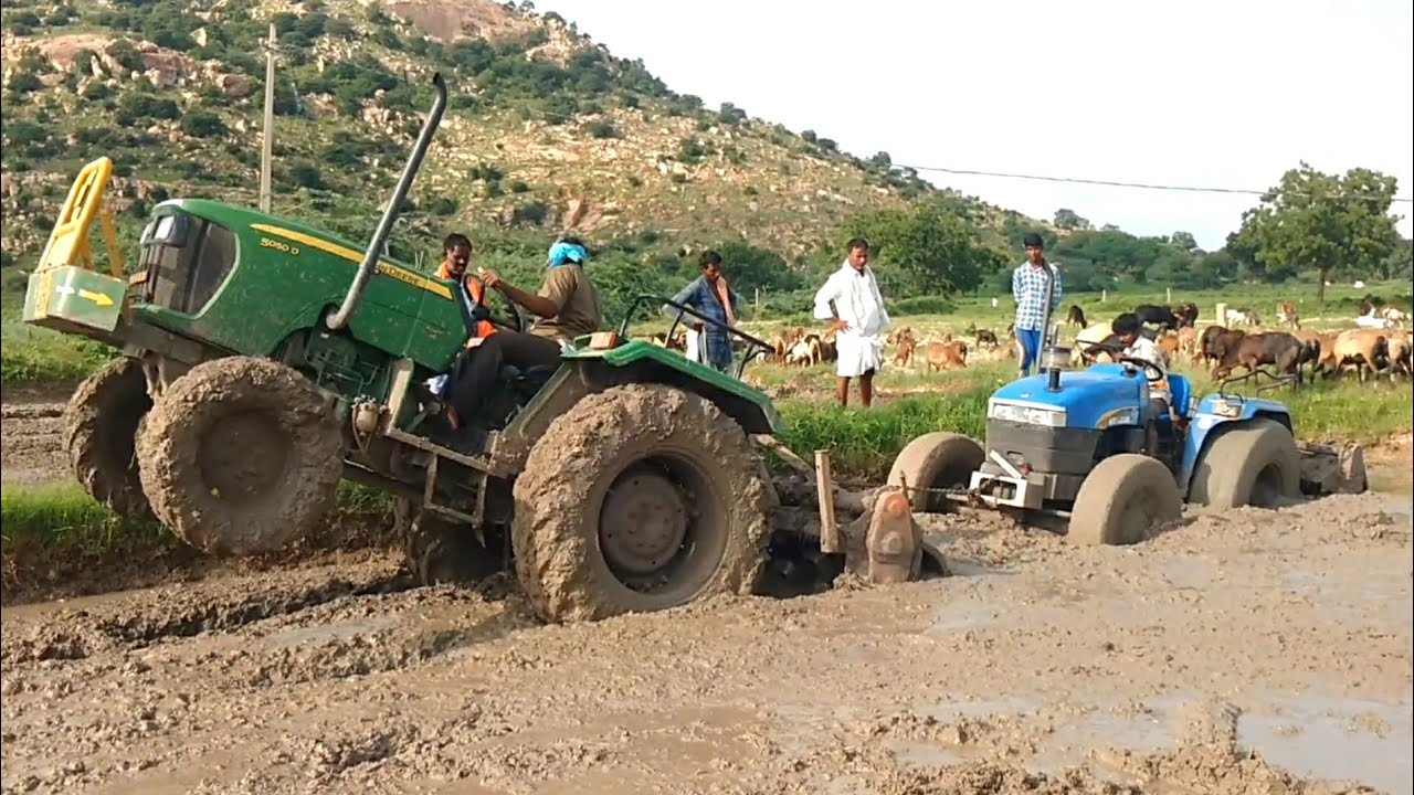 New holland tractor stuck in mud Rescued by John Deere tractor - YouTube