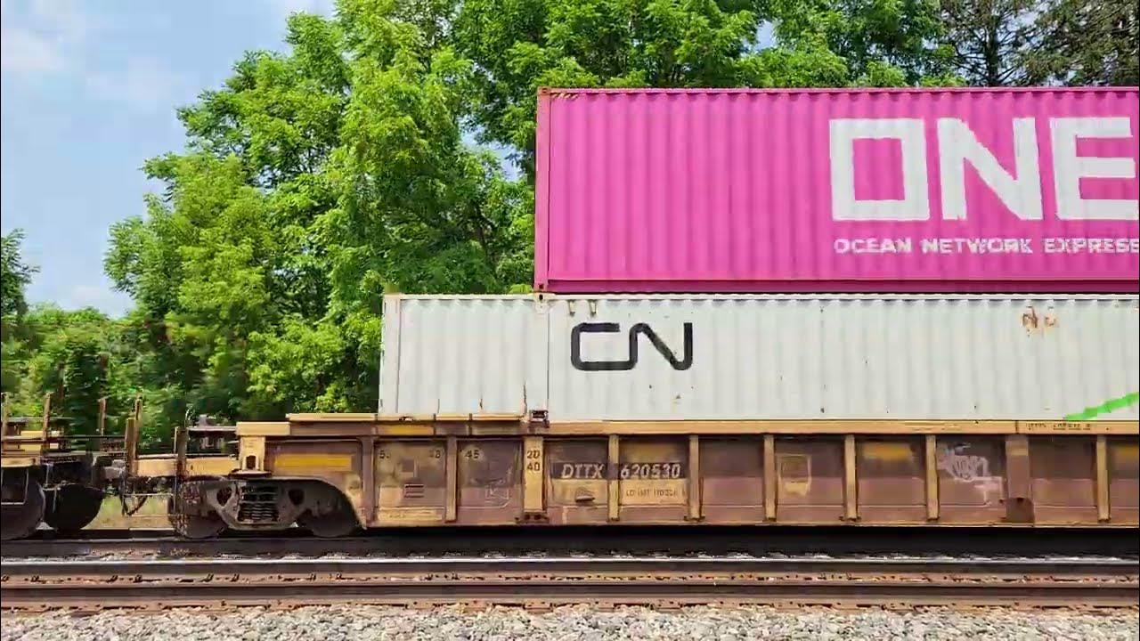CN 5675, 2501 pull a Westbound intermodal container in well car freight train at Vicksburg, MI ...