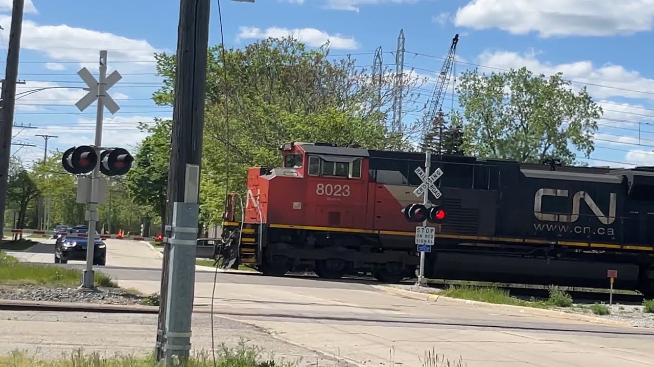 CN #8023 (SD70M-2) & GECX #2037 (CN #3126) lead CN M385 south through Trenton, MI (5/17/22 ...