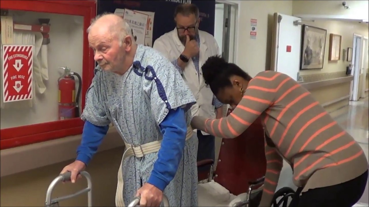 Physical Therapy Education. Support elderly to walk with the walker ...