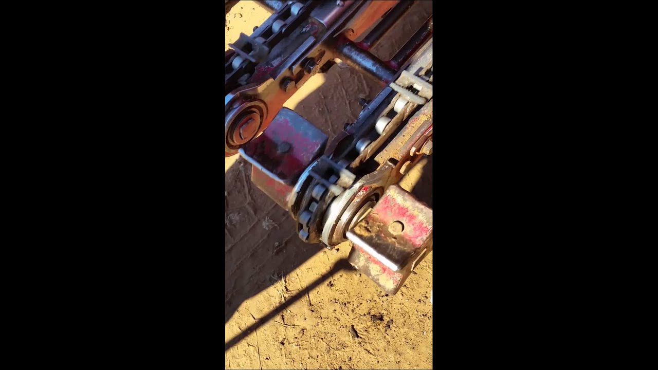 Putting chain back on cotton module truck - YouTube