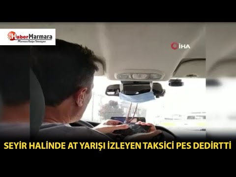 Seyir halinde at yarışı izleyen taksici pes dedirtti