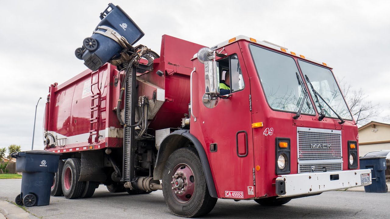 Red Wittke Crocodile Mack LE Side Loader Garbage Truck on Curbside ...