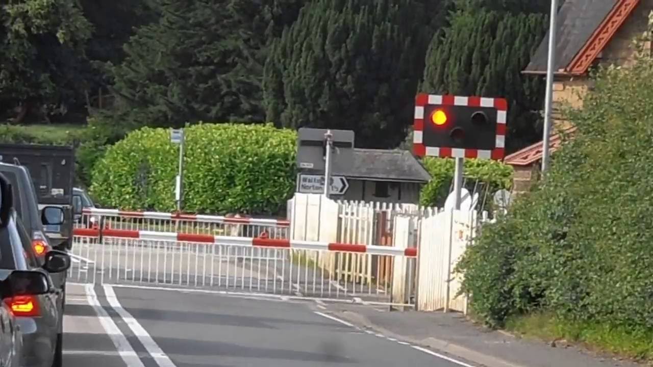 Arriva Trains Wales train at Onibury Level crossing Shropshire England ...