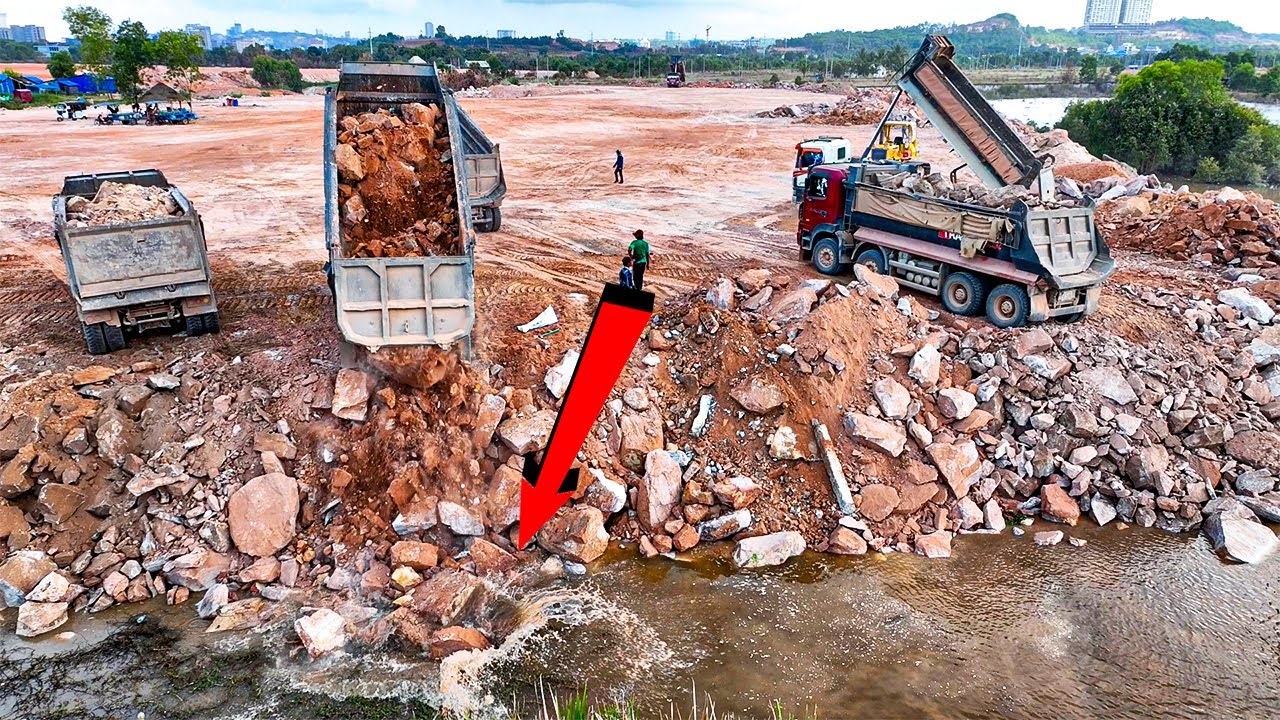 Large scale Land Restoration Process large dump truck unloading large ...