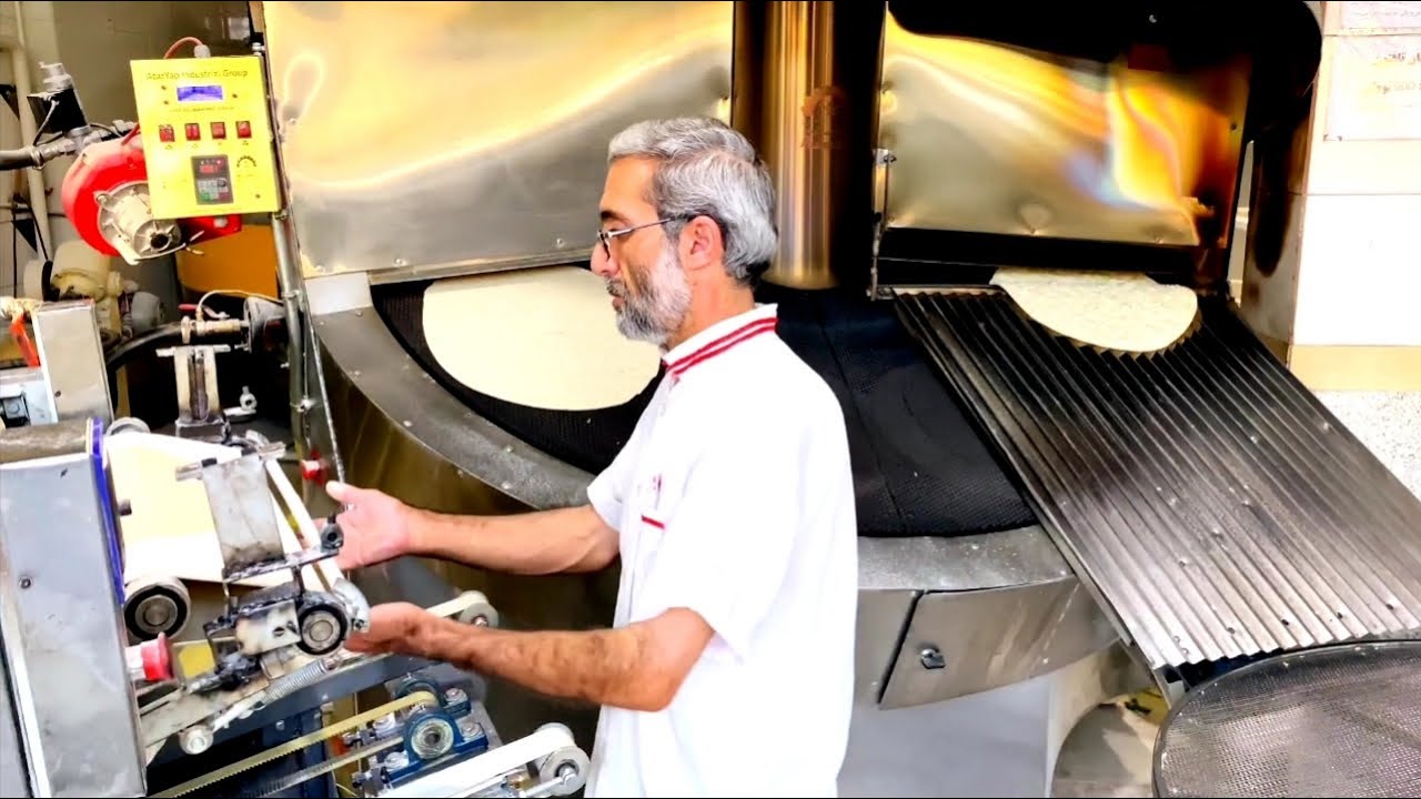 Fully automatic baking of Iranian tafton bread in an Iranian bakery ...