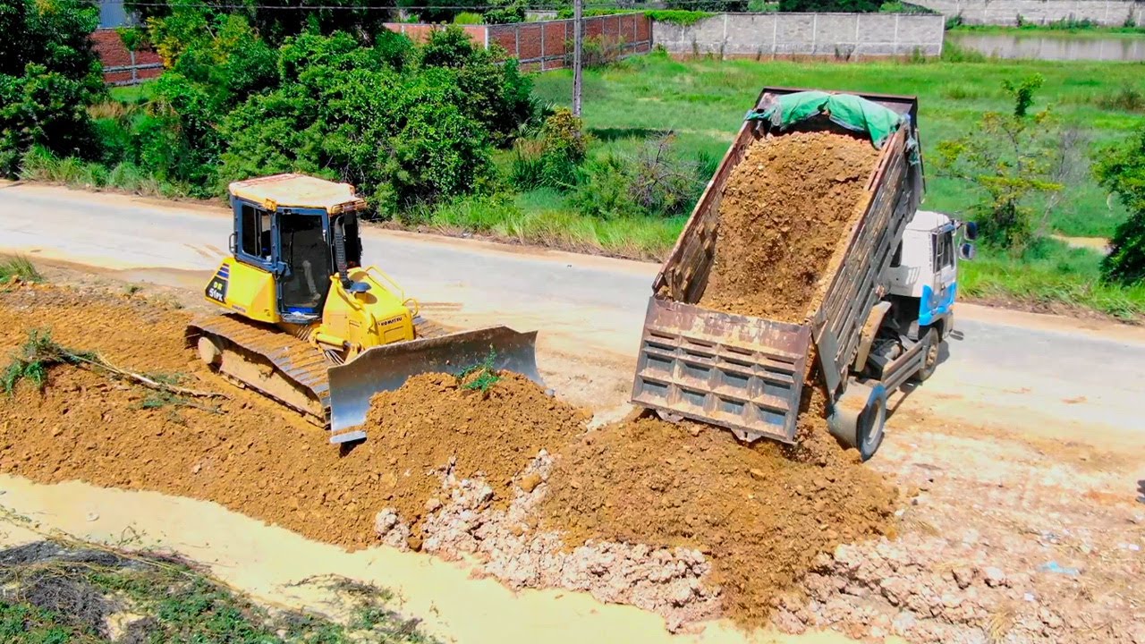 Impressive Bulldozer D51p pushing soil rock & Dump truck transport into ...