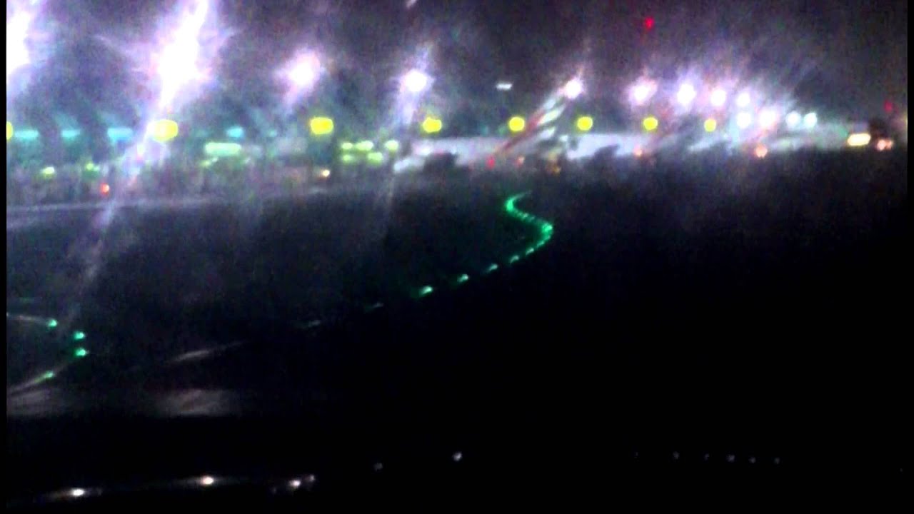 Emirates Boeing 777-300ER night landing in Dubai International airport ...