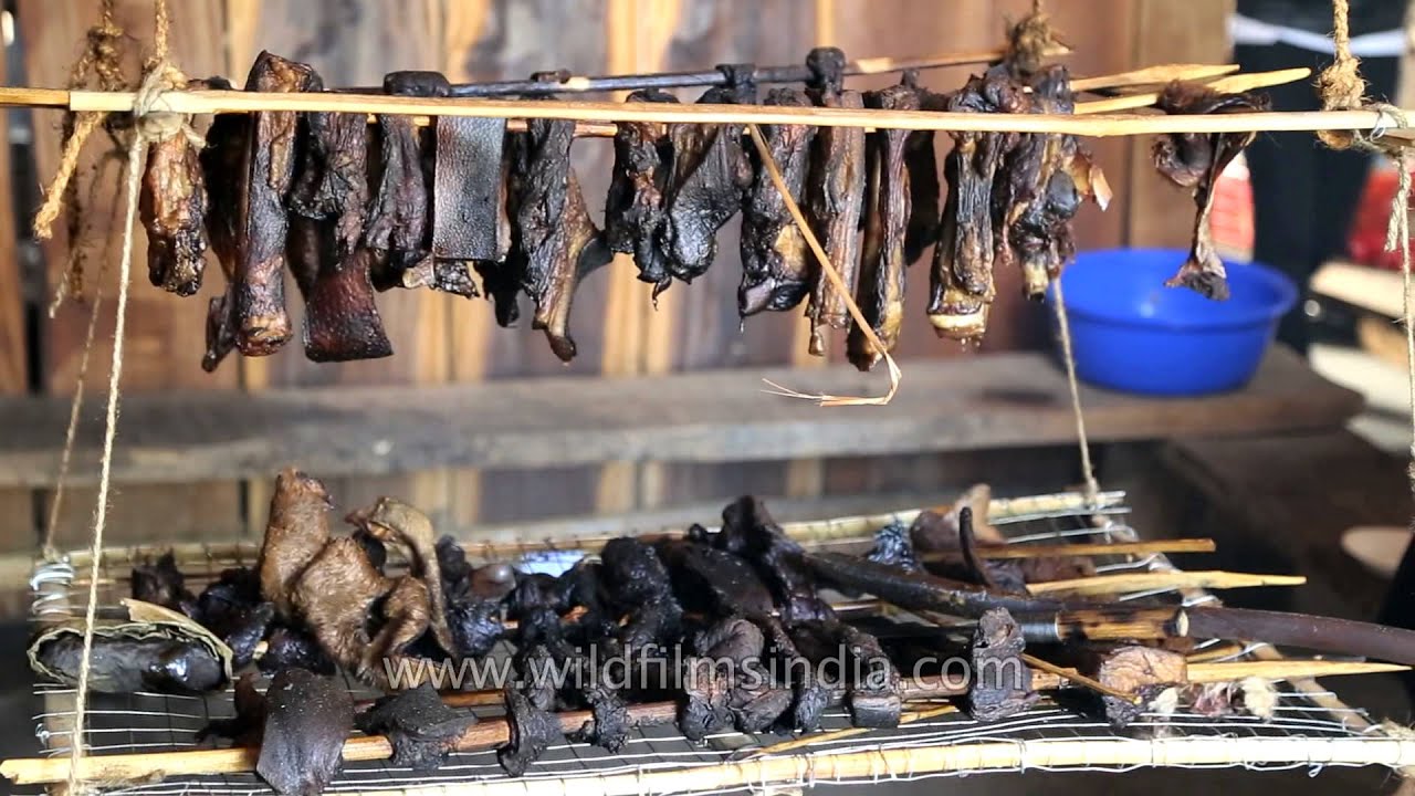 Strips of pork meat being smoked over a wood fire at Naga Heritage ...