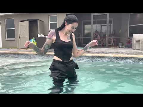 Lexie and Mandy are having fun in the pool fully clothed