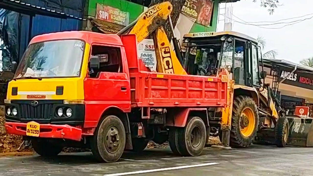 An earthmoving machine loading soil into a tipper lorry #earthmover #tippertruck #lorry - YouTube