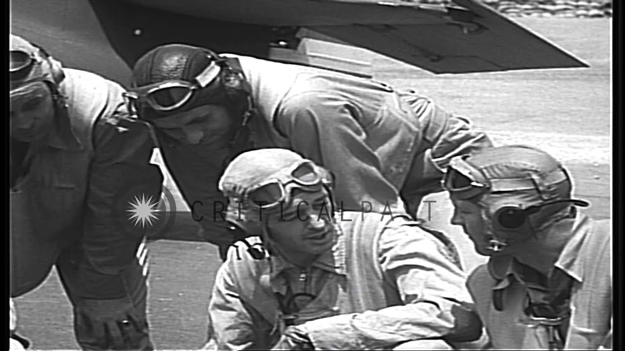 US Navy Fighter pilots of VF-3 sit near an F4F and converse at Kaneohe ...