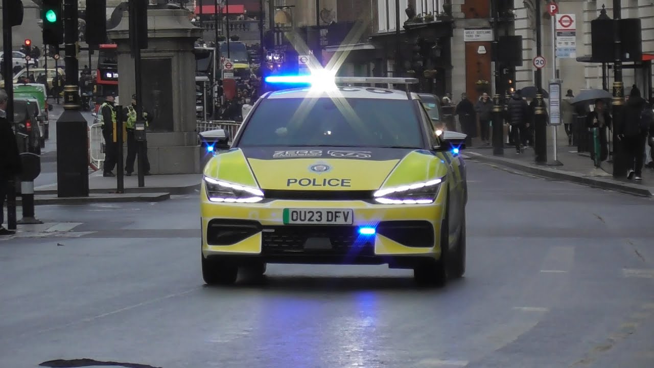Marked and unmarked BTP Kia EV6 responding through Trafalgar Square ...