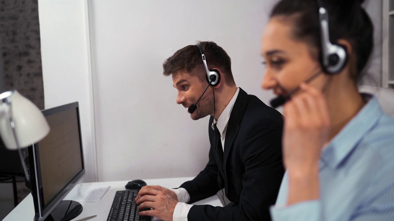 Man and woman working in a call center - YouTube