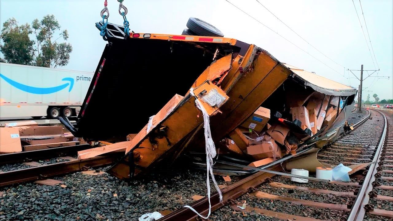 Amazon work truck crashes and flips onto train tracks - YouTube