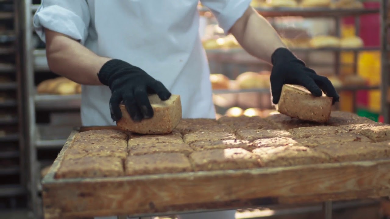 rotation view of just baked steaming loaves of bread being put by - YouTube