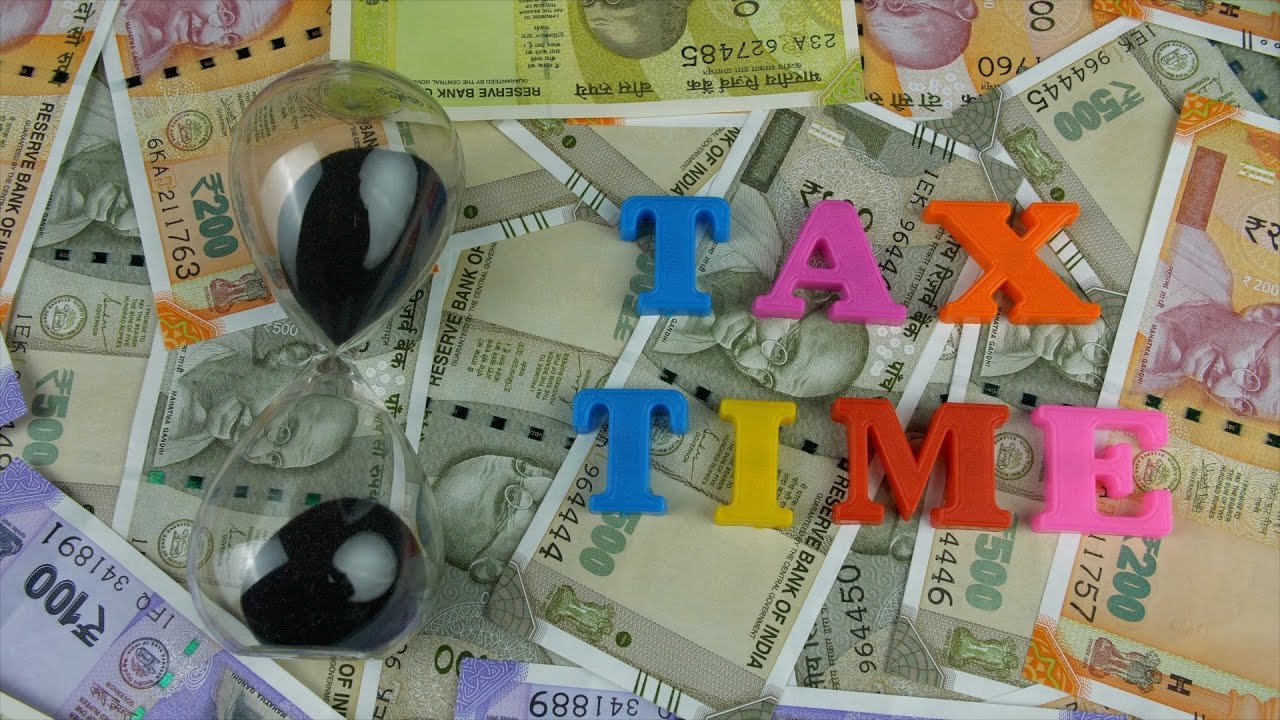 Closeup shot of a sand clock and "Tax Time" words composed wit ...