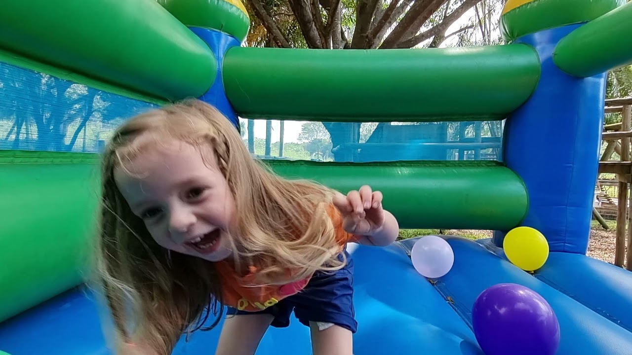 Outdoor Playground Fun For Kids With Jumping Castle, Balloons, Playball ...