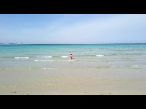 Young Woman in Bikini in Blue Sea on Skyline Background. Drone View Woman in Turquoise Sea | Stock