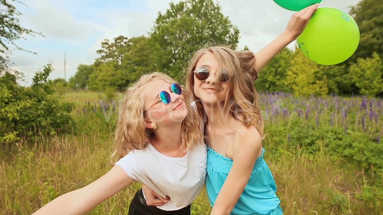 Two young girls are best friends cuddling with balloons - YouTube