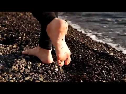 Girl walking on rocky beach with beatutiful bare feet!  Feet worship
