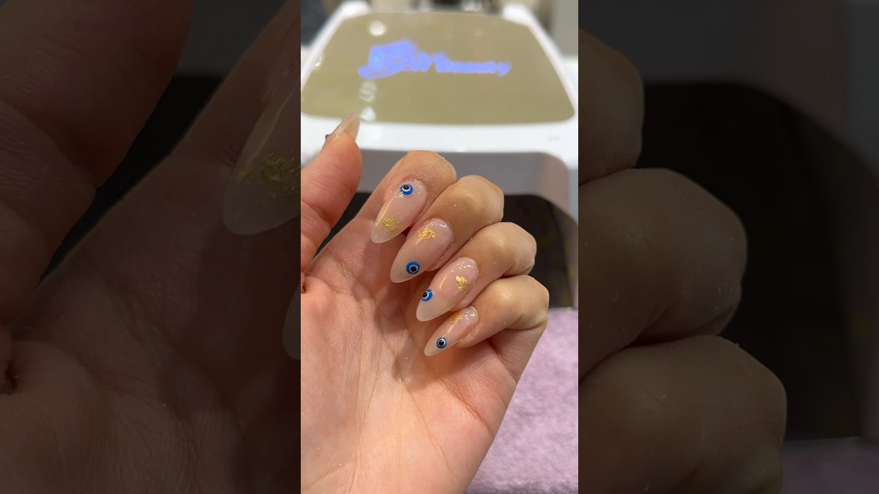 Evil eye almond shape nails #goldfoilnails #nailartdesigns #summernails ...