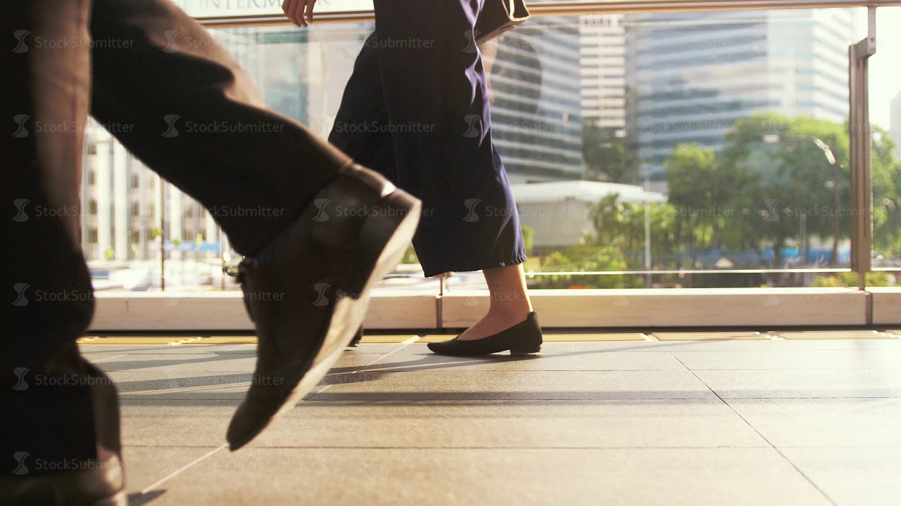 People's feet walk on pedestrian crossing on a busy day in the center ...