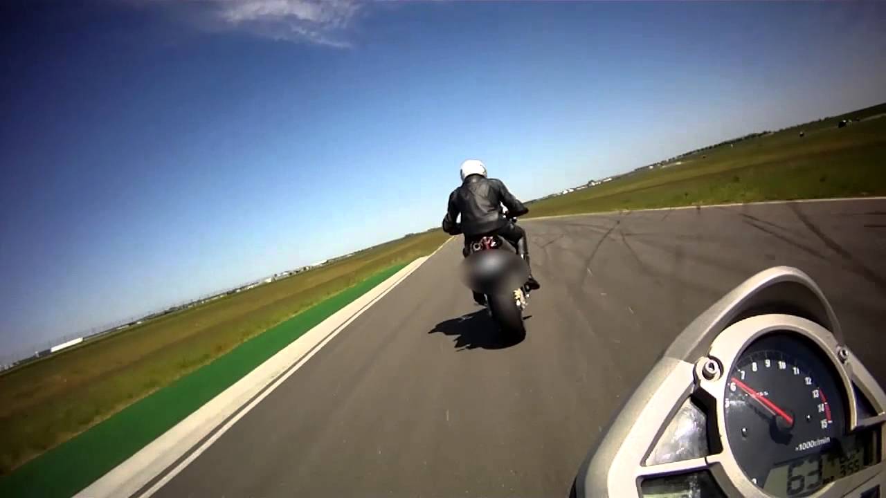 Above Knee amputee riding a motorcycle (aprilia dorsoduro factory) with ...
