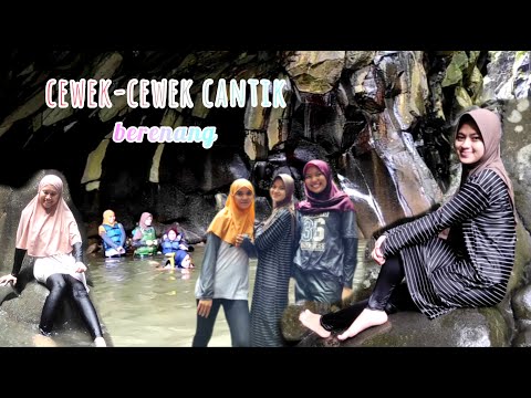 cewek cantik berenang di air terjun berani lompat dari tebing