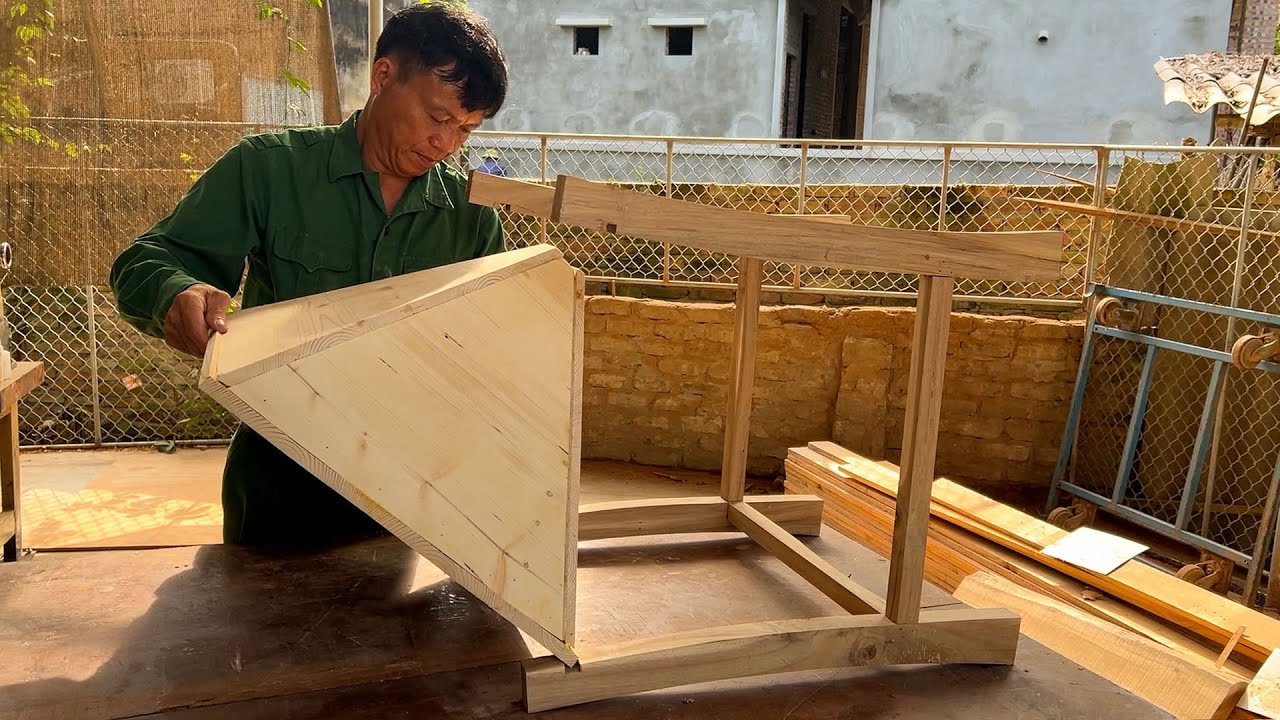 Woodworking: The carpenter creates a unique triangular cabinet a ...