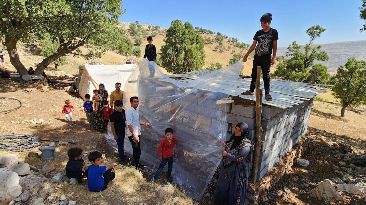 Construction of the roof of a nomadic hut with wood by a nomadic family ...