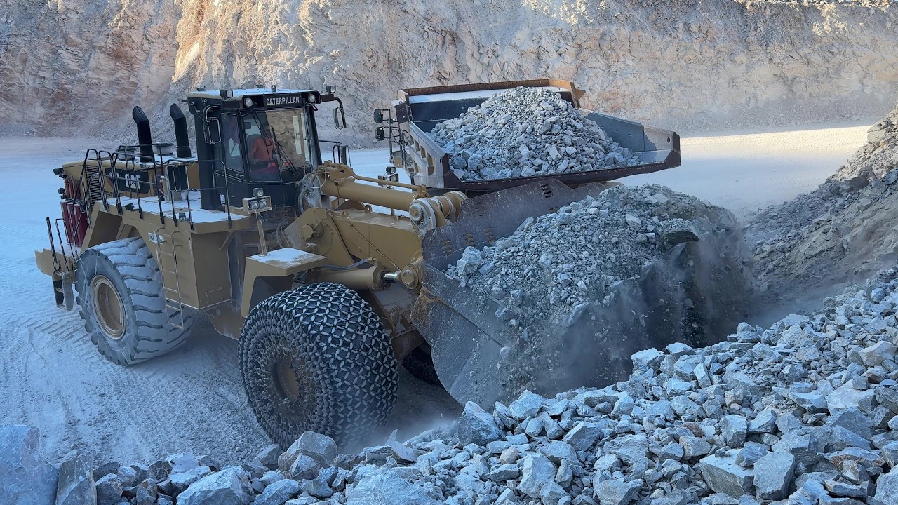 Caterpillar 992K Wheel Loader Loading Blasted Rocks Onto CAT 777F ...
