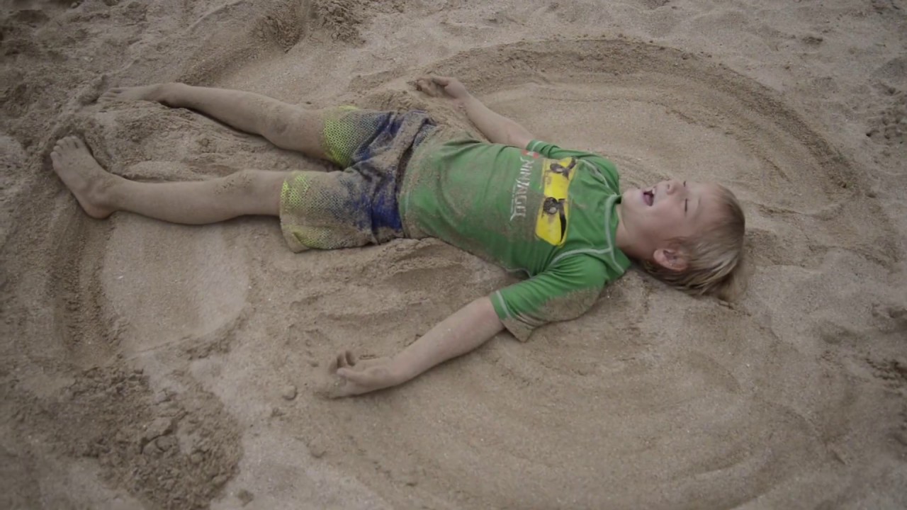Making sand angels at the beach - YouTube