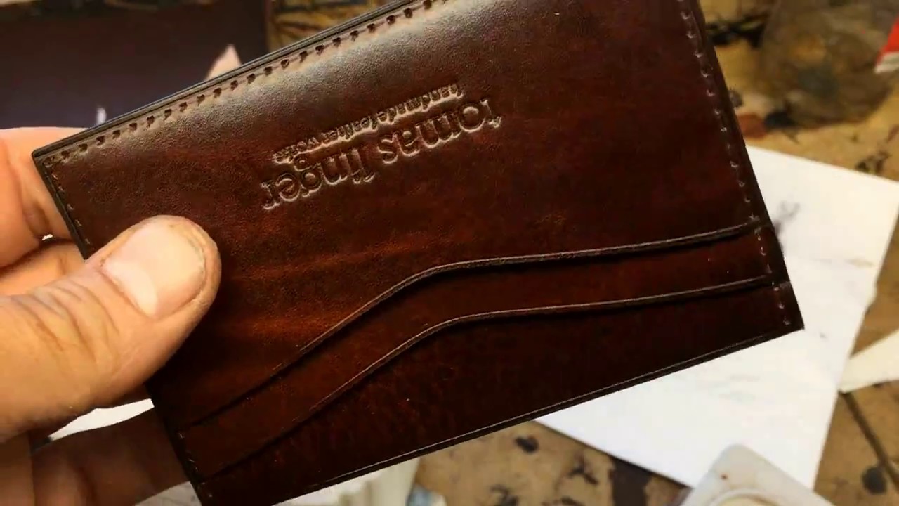 Card case and banknotes in production. Handmade leather. Handmade ...