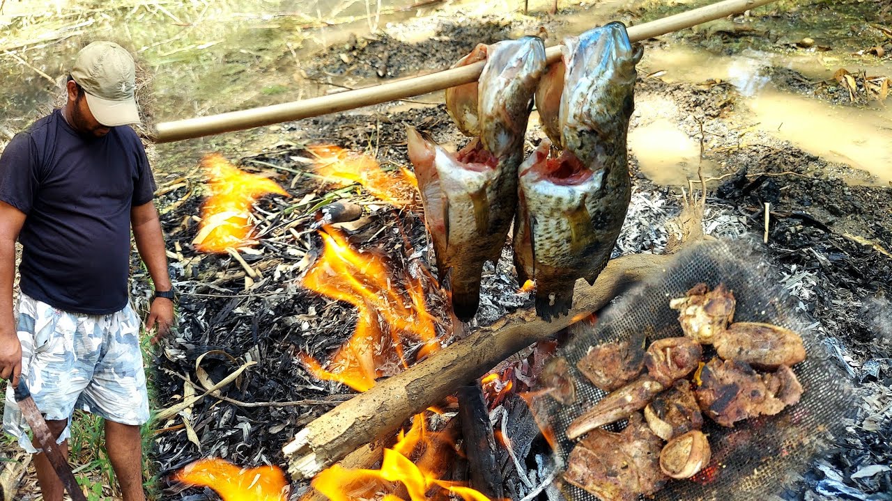 ROASTING PORK AND FISH WE CAUGHT OVER A BIG FIRE INSIDE THE RIVER - YouTube