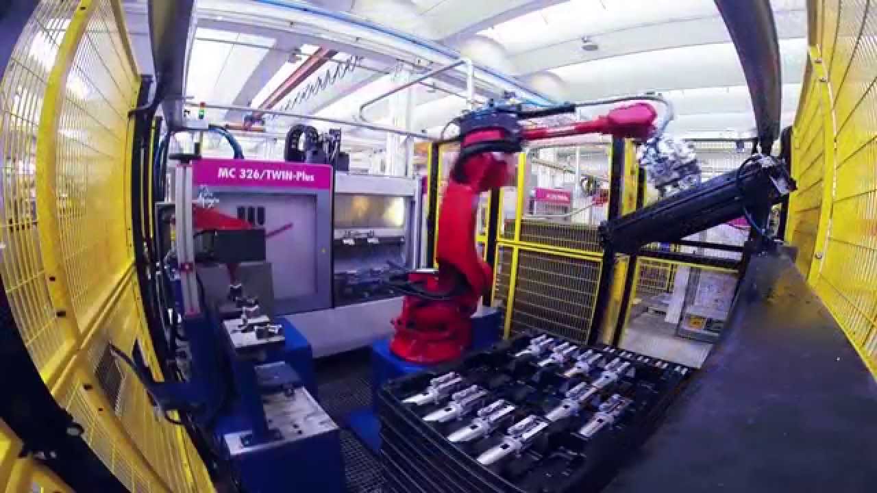 Comau NS12 in machine tending, marking, washing, palletizing - YouTube