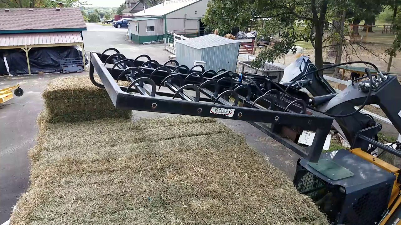 Kuhn 10 bale on edge hay grabber, unloading (3) - YouTube
