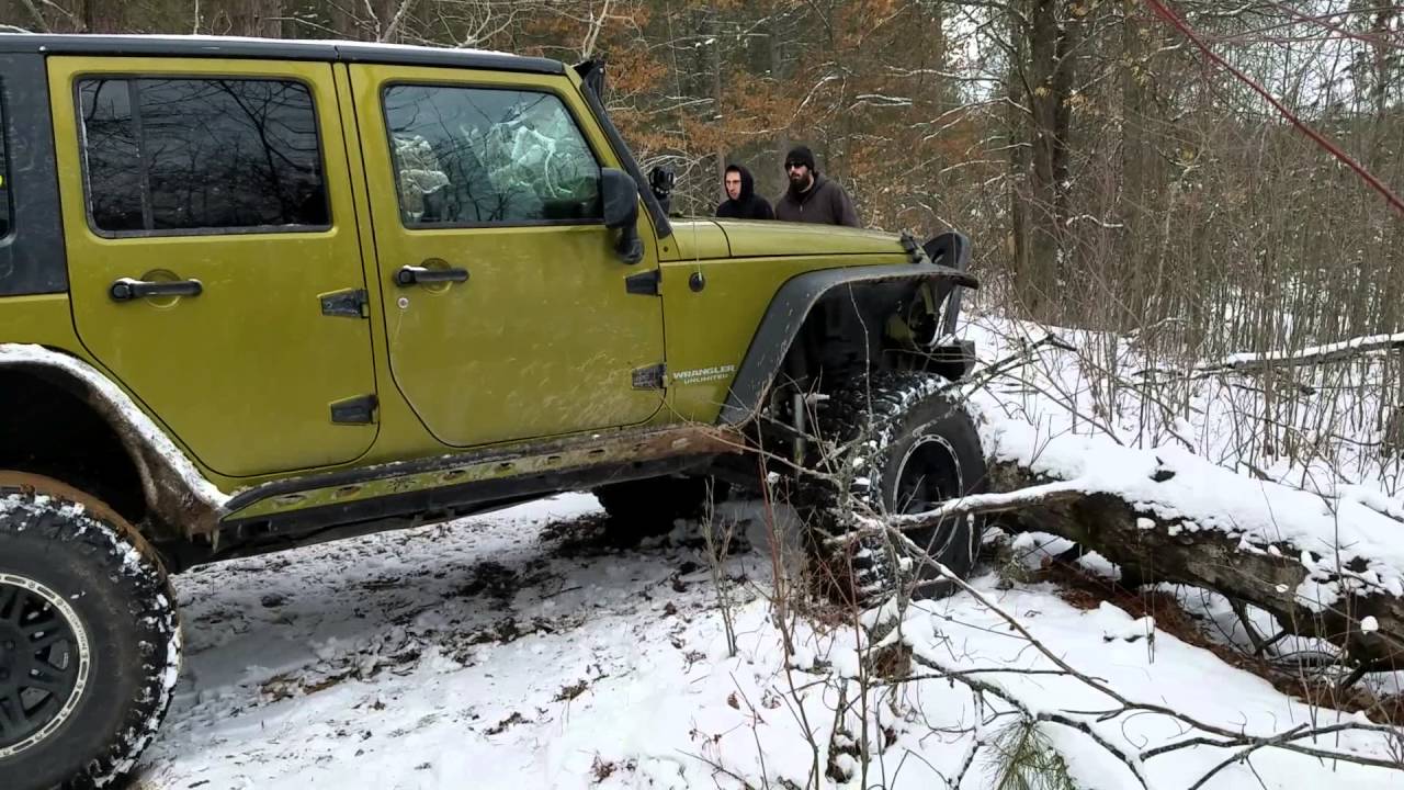 Jeep jk crawls over downed tree - Cadillac Michigan - YouTube
