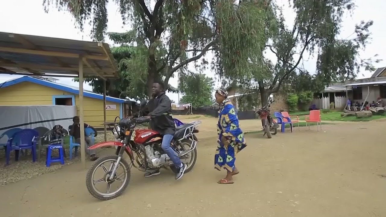 Ebola survivor with bike helps ease fear in Congo - YouTube