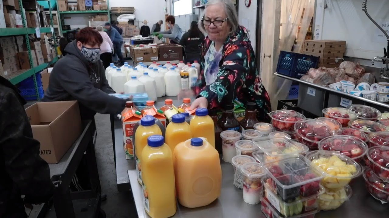 People are waiting in line at The Vineyard food pantry during the COVID ...