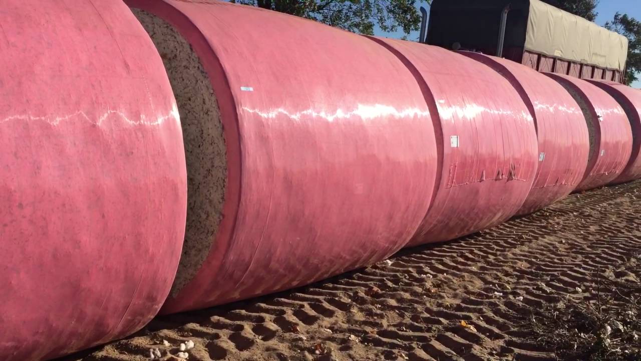 Palomo loading round cotton module in Missouri - YouTube