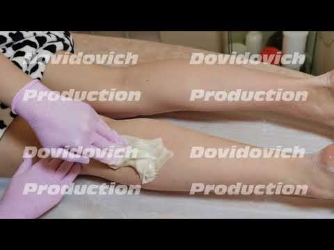 Depilation of legs with sugar paste or Shugaring. Beauty saloon.