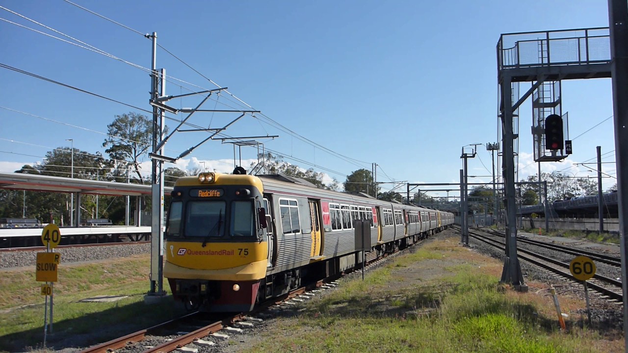 QR electric suburban train number 75 approaching Petrie Station on a ...
