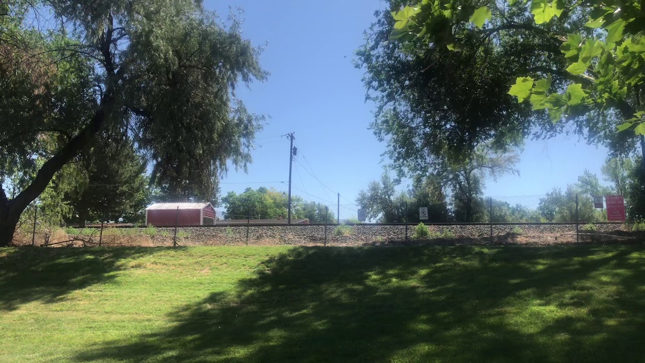 C45ACCTE 7495 leads a grain shuttle through Clinton Utah at meadows ...