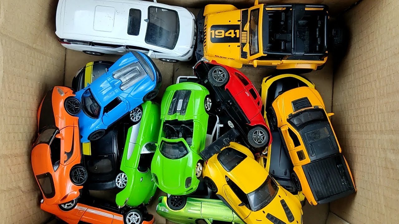 Box full of various miniature cars Peugeot, Jaguar, Pagani, Hyundai ...
