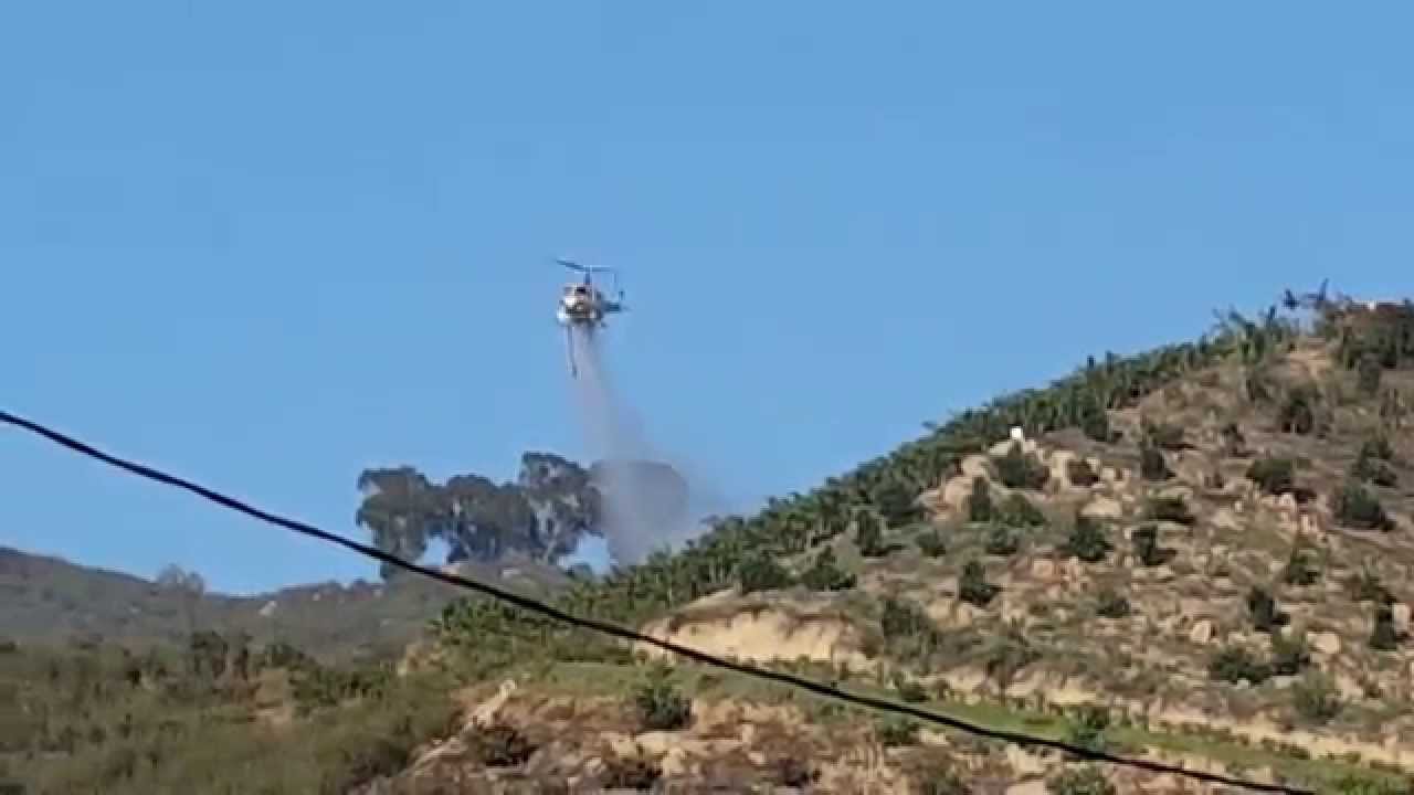 Cal Fire helicopter dropping water to contain the DeLuz fire on 08/09 ...