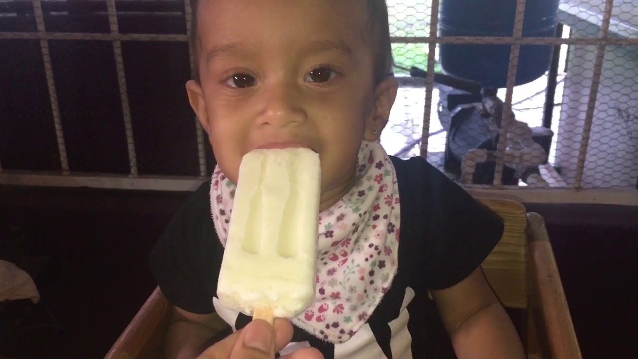 Twin toddlers first taste of likka stick - YouTube