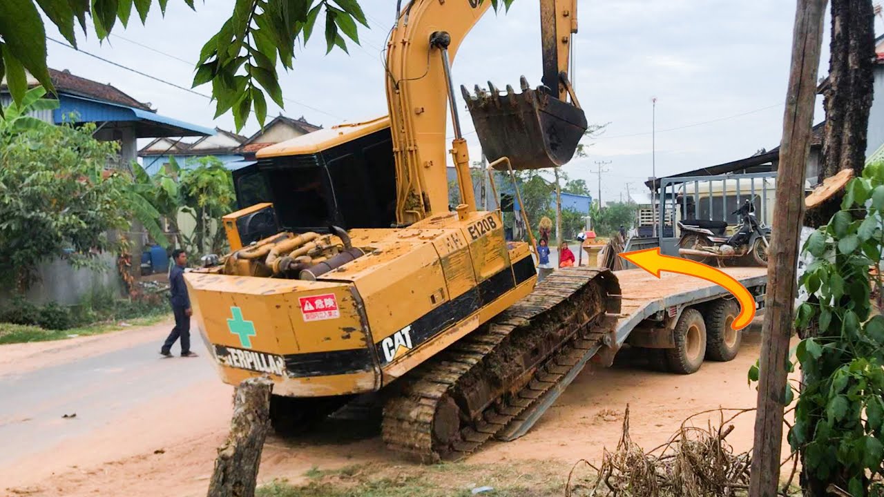 Experienced Excavator CAT Operator Loading And Unloading Excavator ...