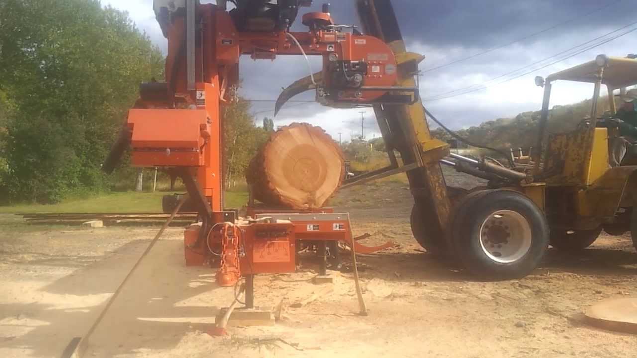 Patrick forklift loading mostly firewood log on mill - YouTube