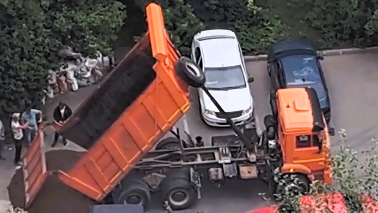 A dump truck unloaded sand in the yard A loader carries sand in a ...